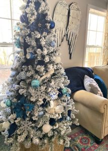 Elegant Flocked Christmas Tree With Blue And Silver Decorations