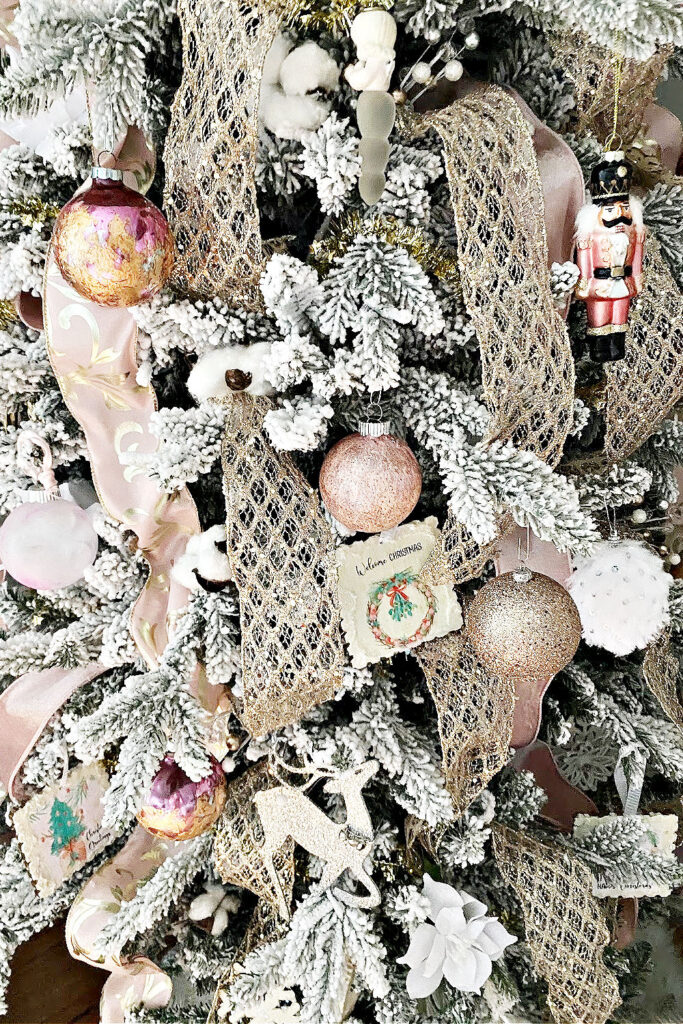 Elegant Pink & Gold Christmas Tree Decorations on a Flocked Tree
